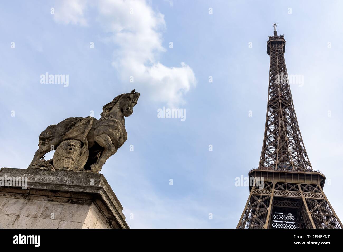 View of the Eiffel tower on a sunny summer day in Paris. It is the ...