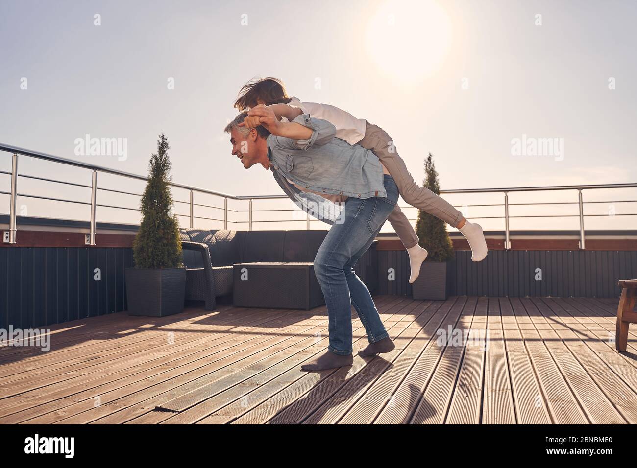 Little cutie boy lying on the back of man Stock Photo - Alamy
