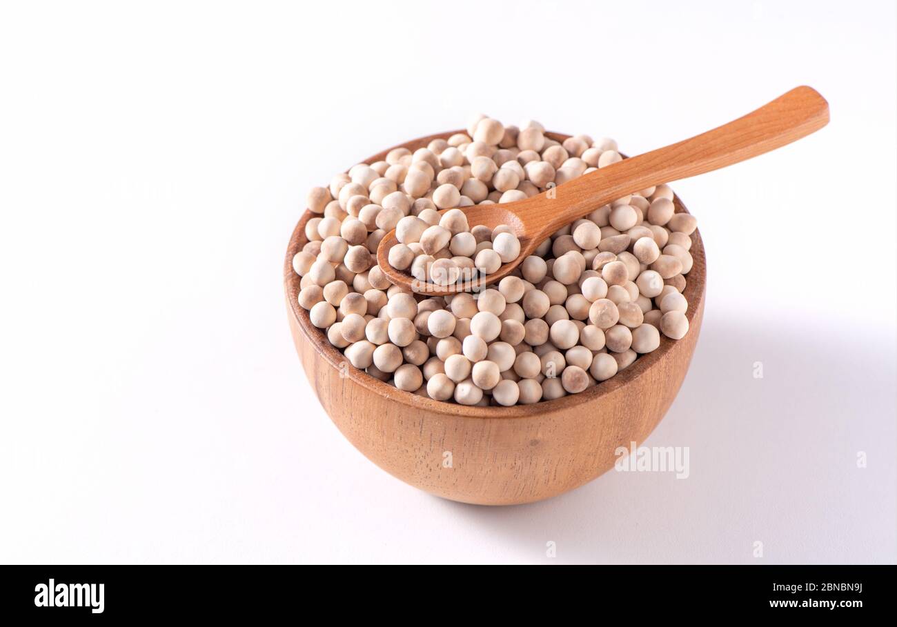 Dry raw brown tapioca pearls in a wooden bowl with spoon isolated on ...
