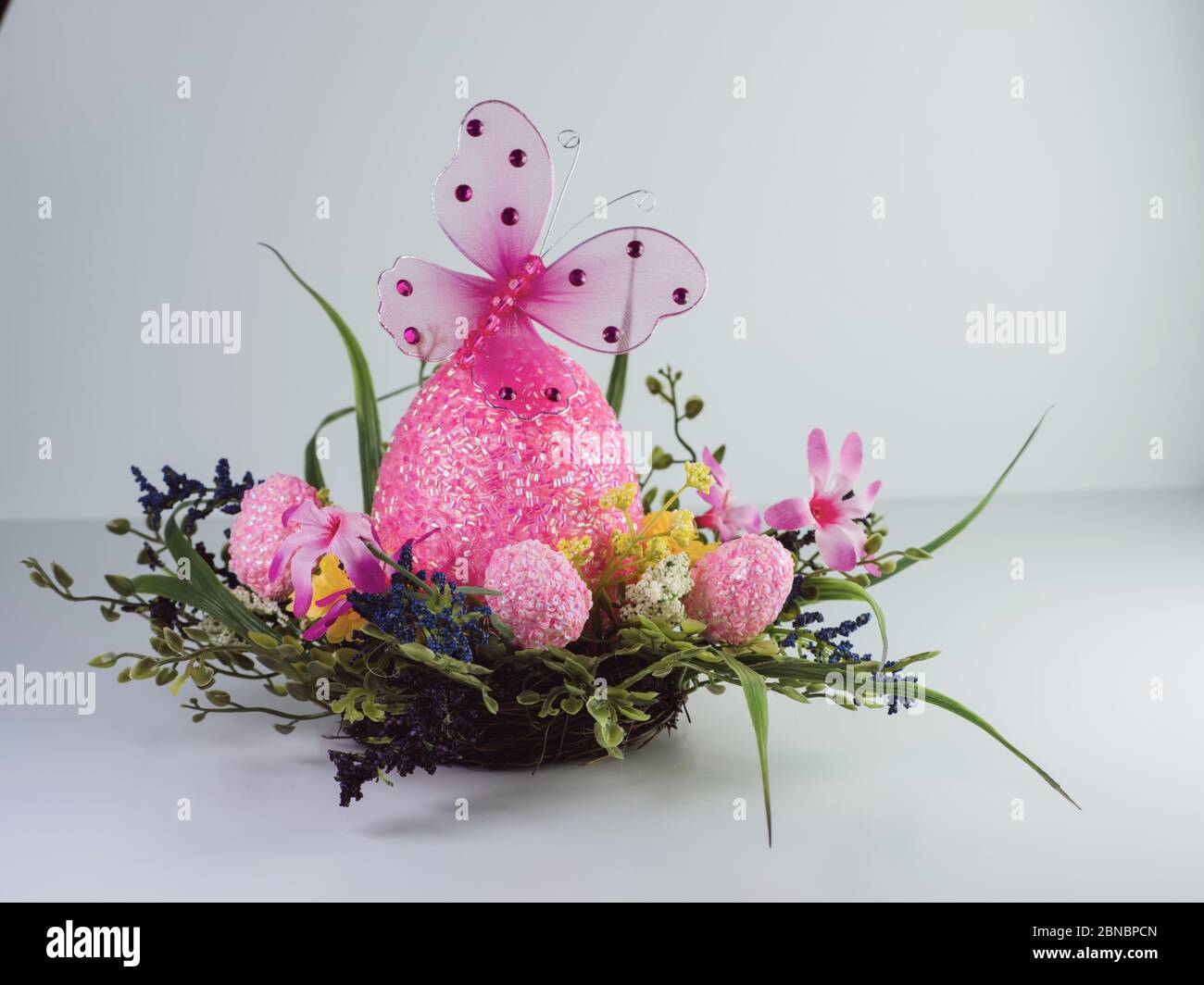 Pink decorative eggs and a butterfly for easter Stock Photo - Alamy