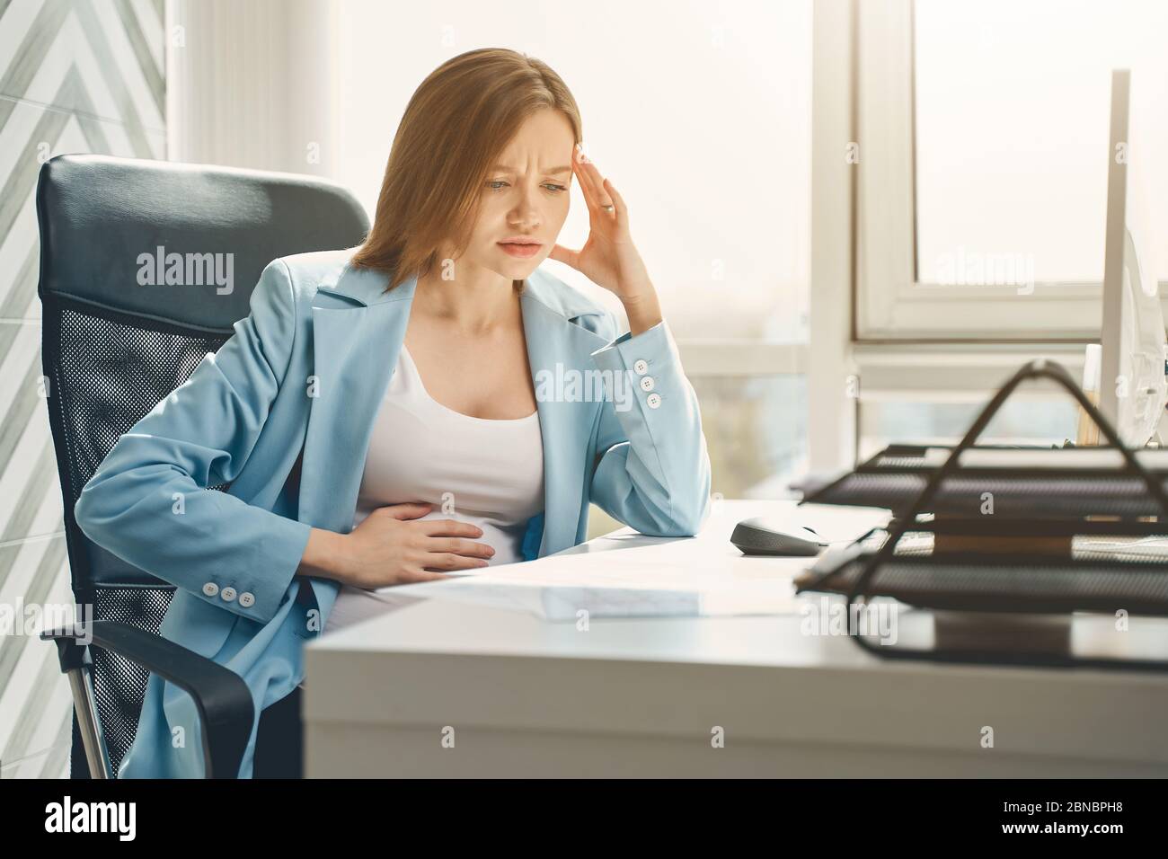 Beautiful pregnant woman feeling stressed at work Stock Photo - Alamy