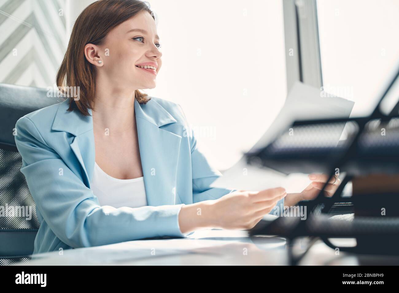 Pretty office lady sitting in hi-res stock photography and images - Alamy