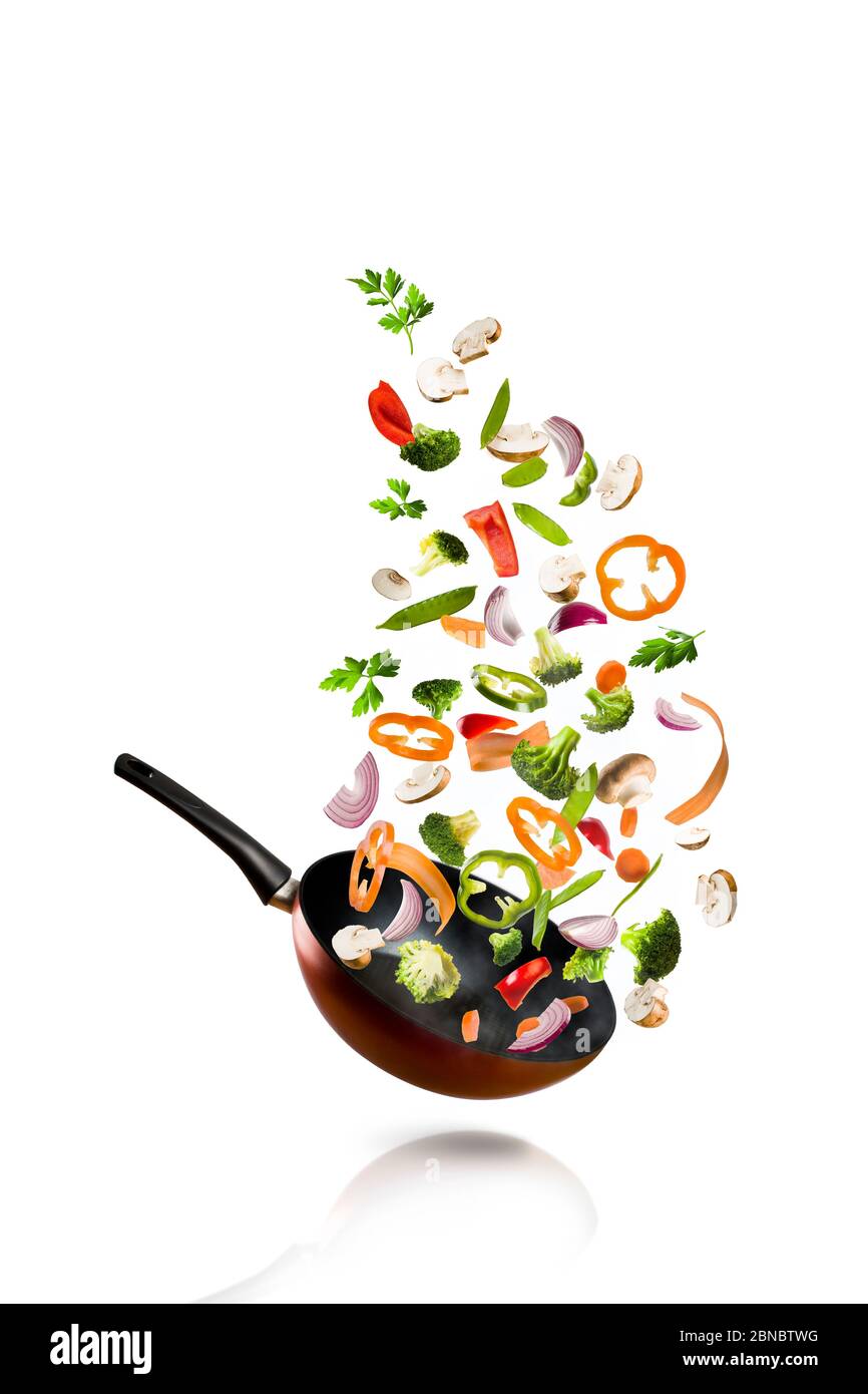 Fresh vegetables flying into a pan, placed on white background Stock ...