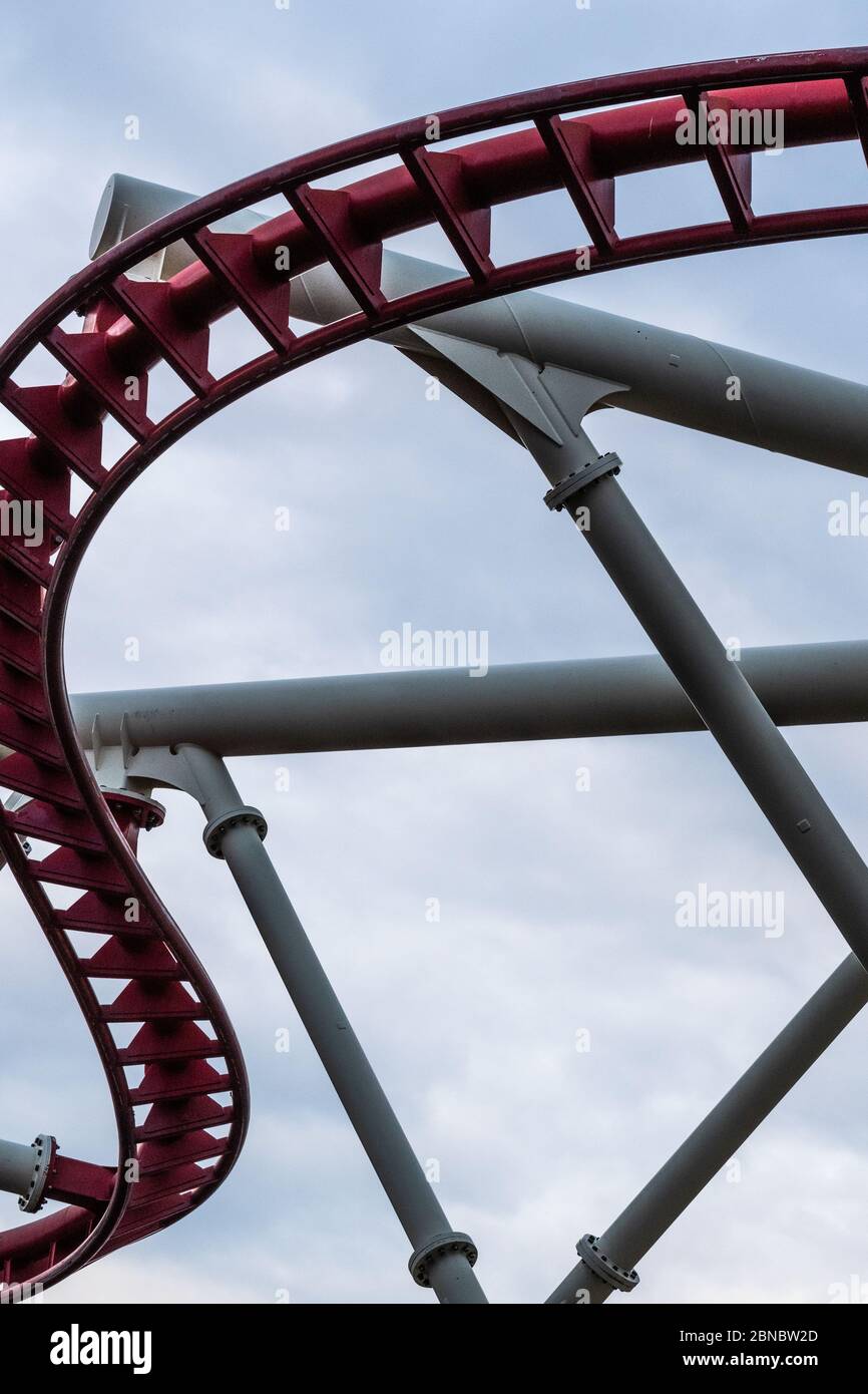 Low angle vertical shot of a roller coaster metal track in an amusement ...