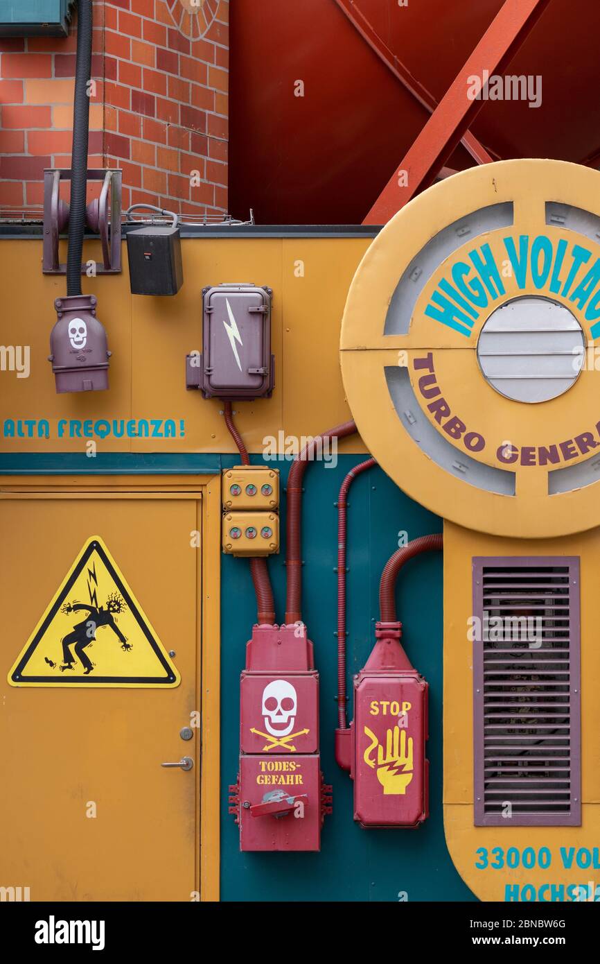 Vertical shot of a generator with different warning symbols Stock Photo ...