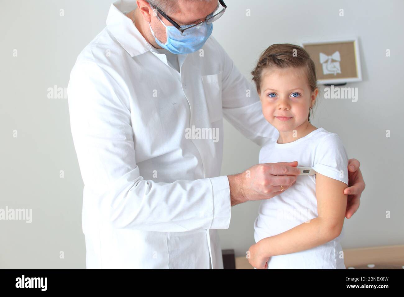 The doctor measures the temperature of a sick child Stock Photo - Alamy