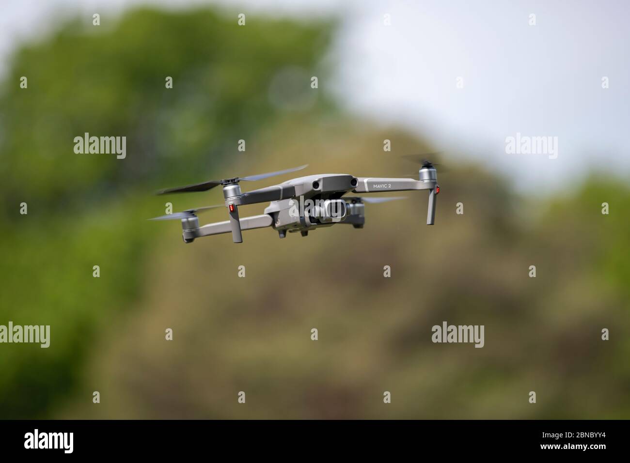 Contemporary drone with camera flying and shooting nature during ...