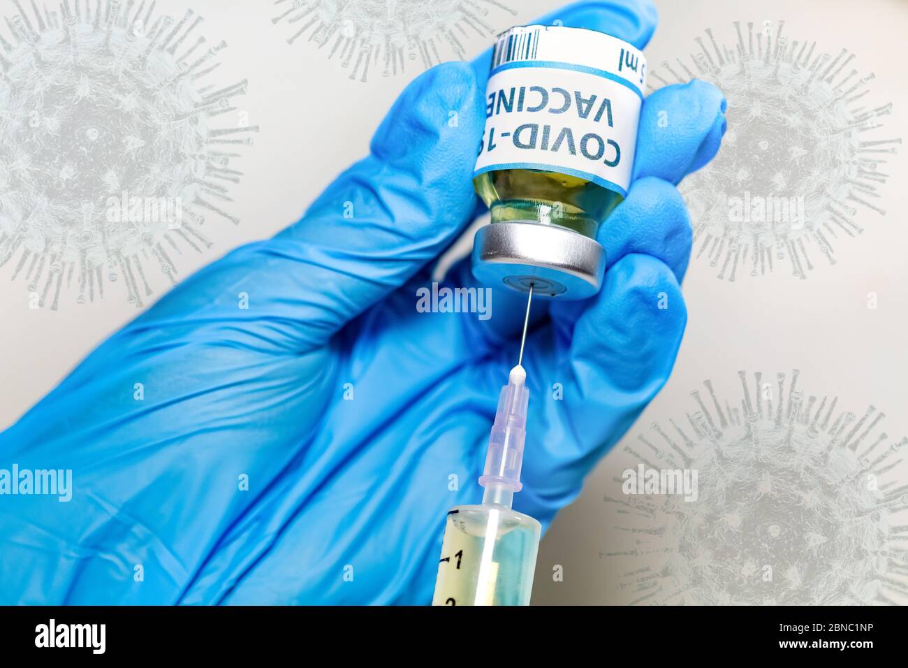 Doctor hands in medical gloves hold a vaccine bottle vial while ...