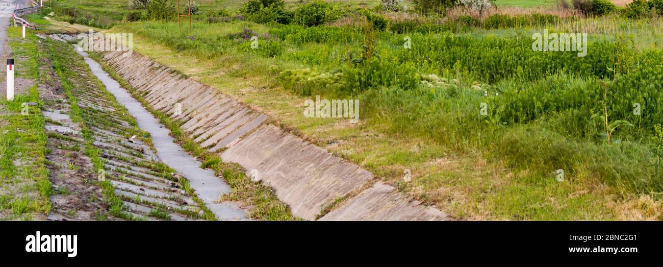 Asphalt road with gutter on the side of the road or with a ditch for ...