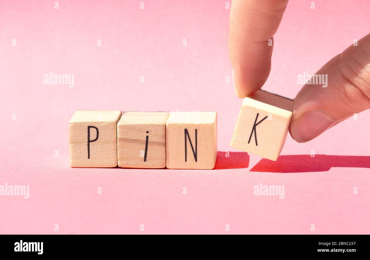Wooden cubes lie in a row on pink background with the word Pink, Pastel ...