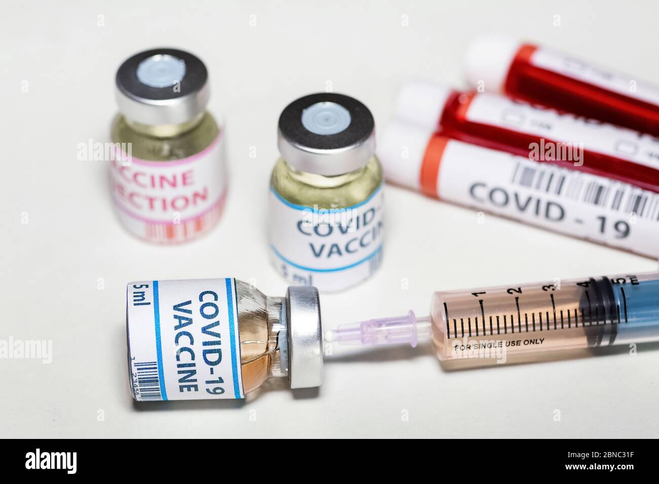 Vaccine bottles with injection syringe, blood sample vials and medical ...