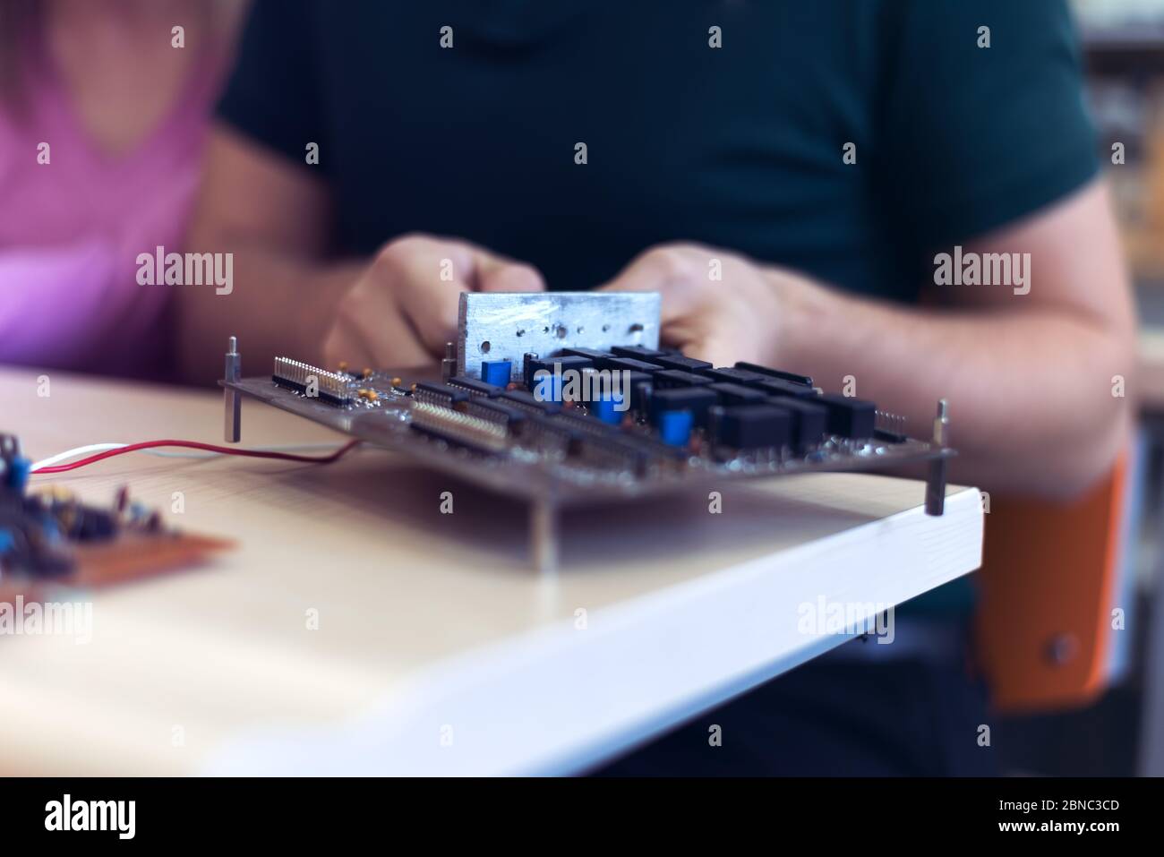 Scientists engineers designing small human robot, setting artificial intelligence humanoid robot ...