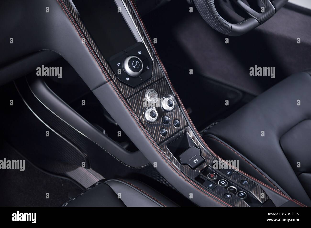 Closeup of the control buttons of a modern luxury car under the lights ...