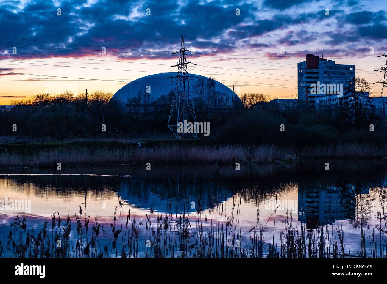 The dome of the inflatable sports complex and the power line pylon ...