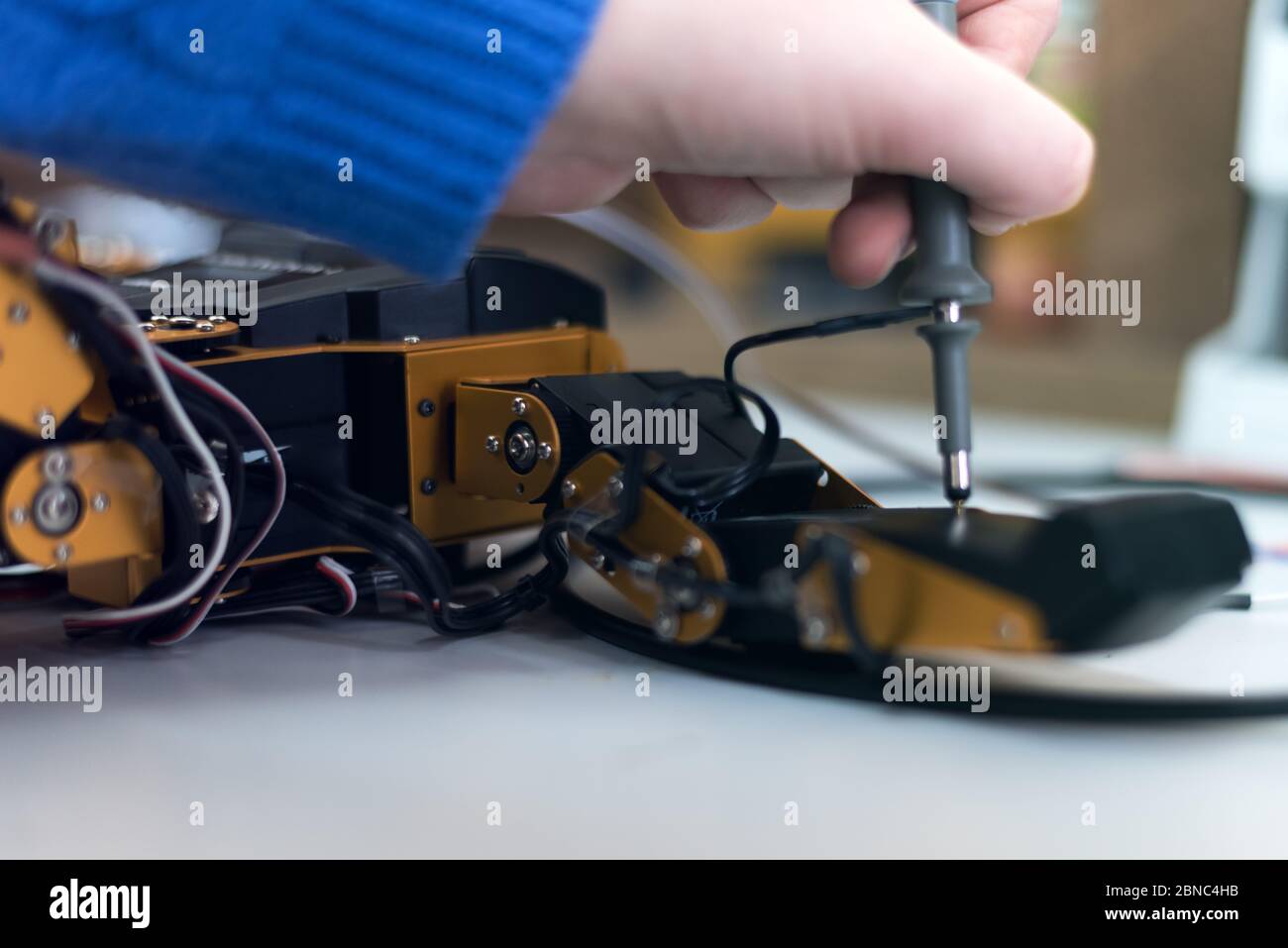 Scientists engineers designing small human robot, setting artificial ...