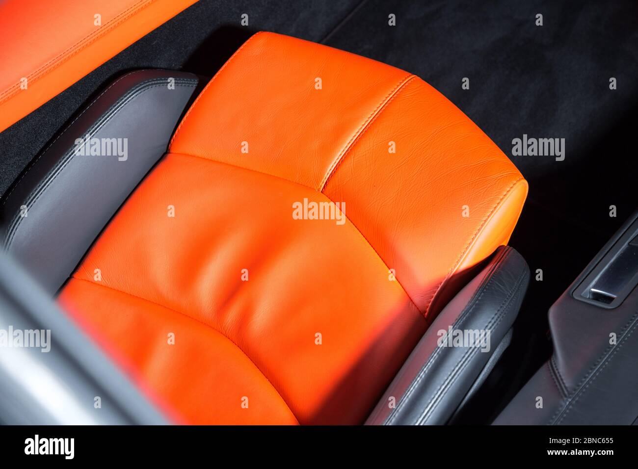 Orange and black leather seats in the cabin of a car Stock Photo - Alamy