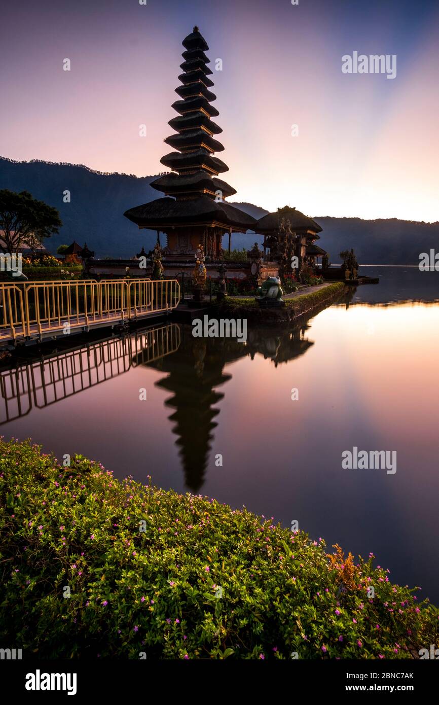 sunrise ray of lights over the temple bali indonesia Stock Photo - Alamy