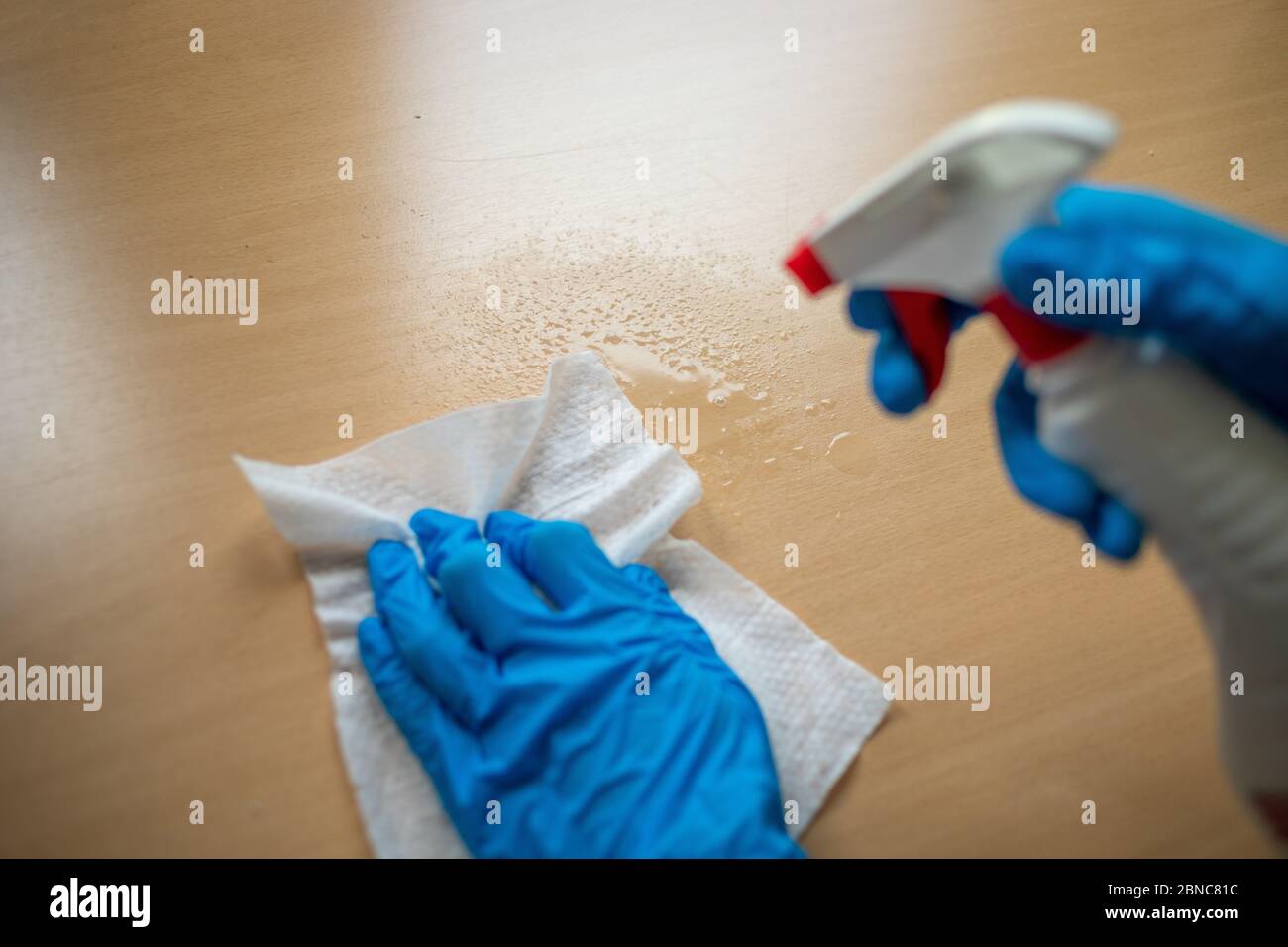 Cleaning home office table sanitizing kitchen table surface with ...