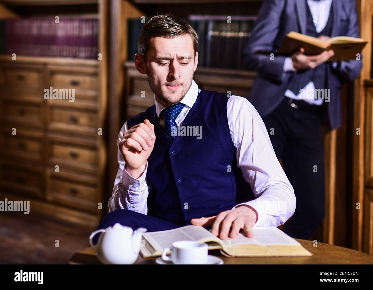 Men in suit, detectives spend leisure in library. Private investigator ...