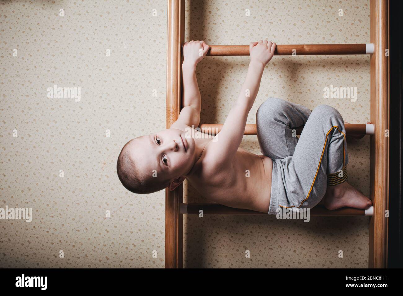 Boy climbing up ladder hi-res stock photography and images - Alamy