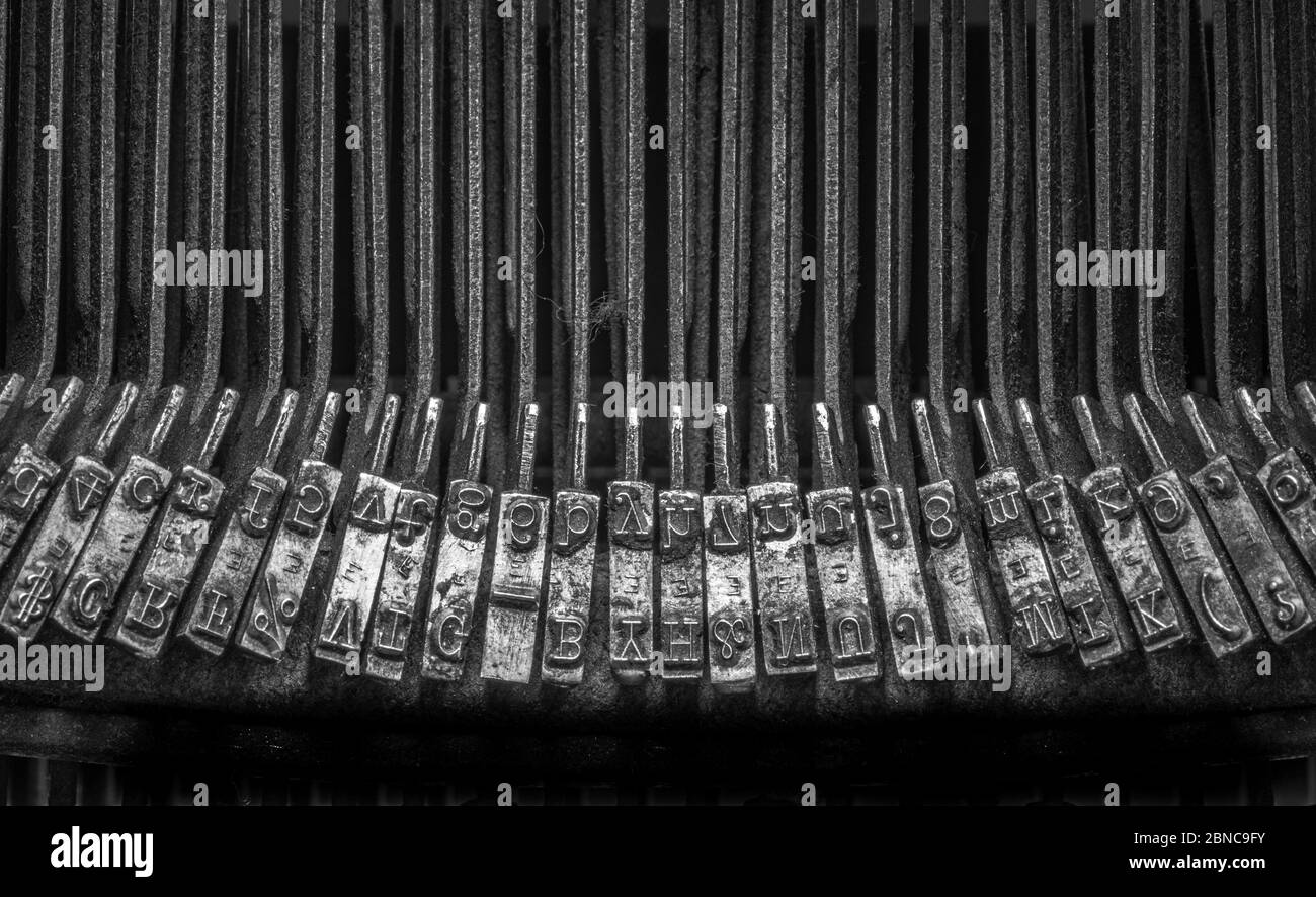 Greyscale closeup shot of the inner keys of a vintage typing machine ...