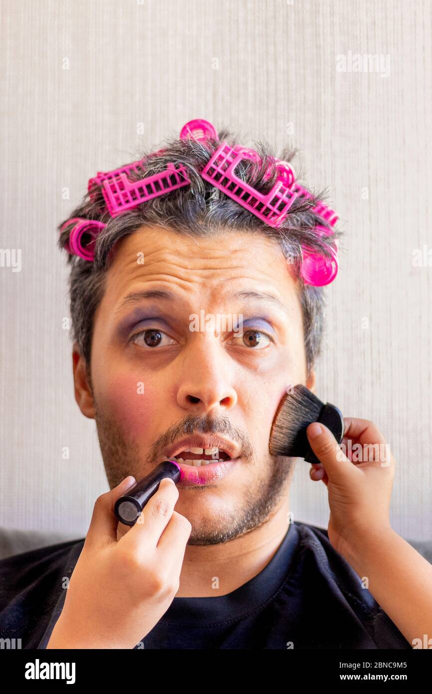 Handsome father is being makeup by the hands of his daughters Stock ...