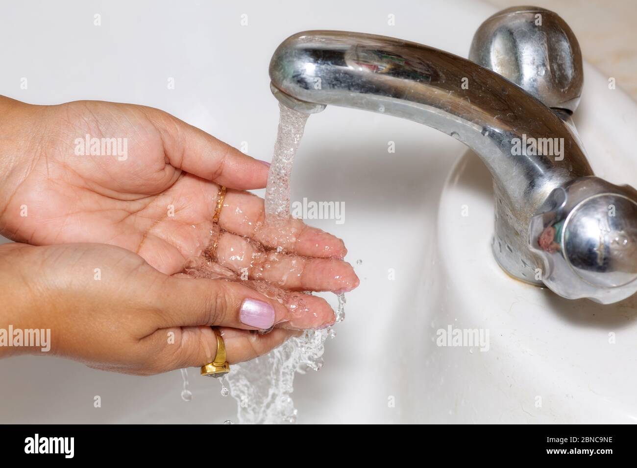 Woman washing hands for hygiene as Corona virus prevention awareness ...