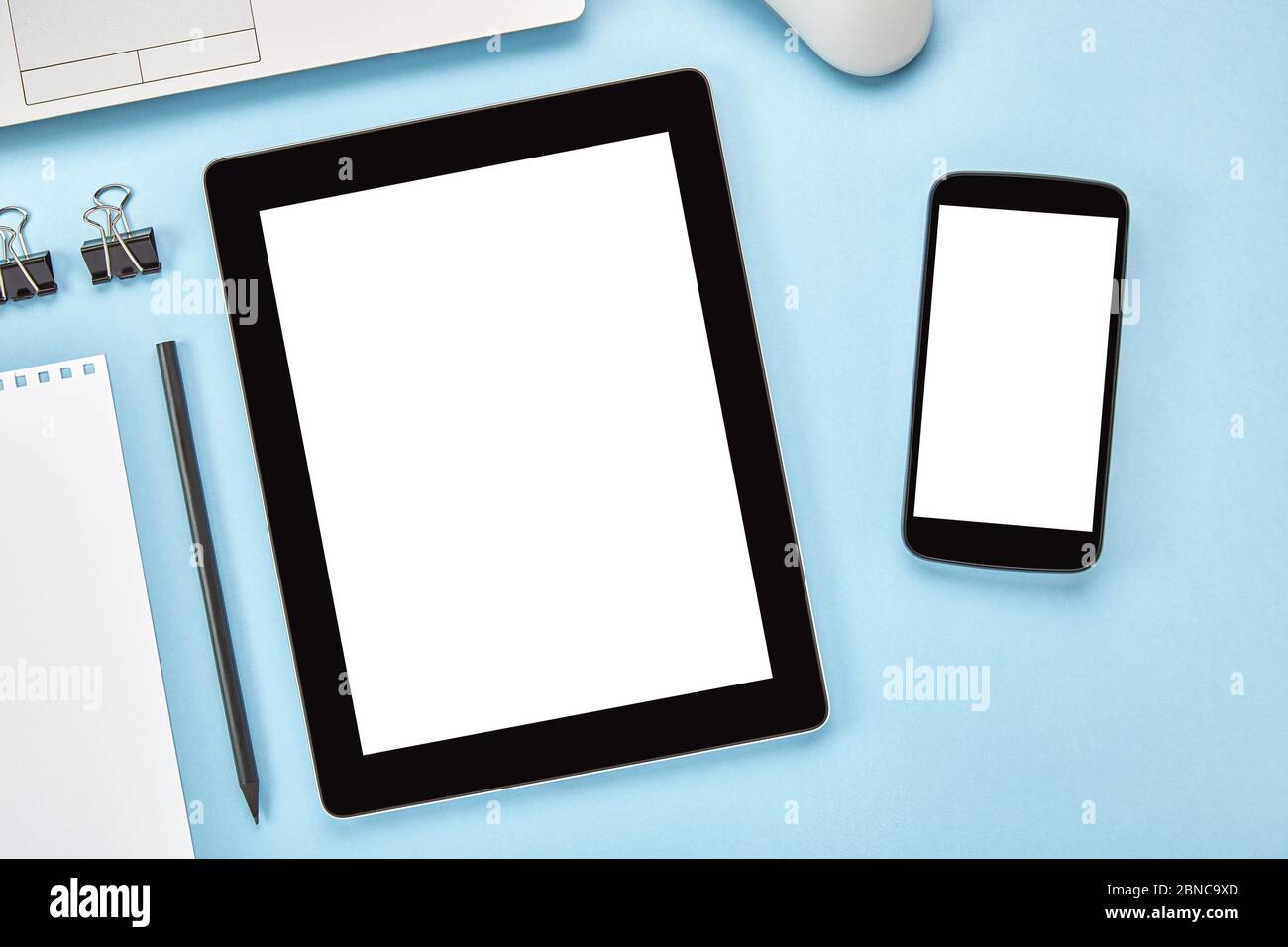 Mockup image of a vertical tablet computer and smartphone with blank ...