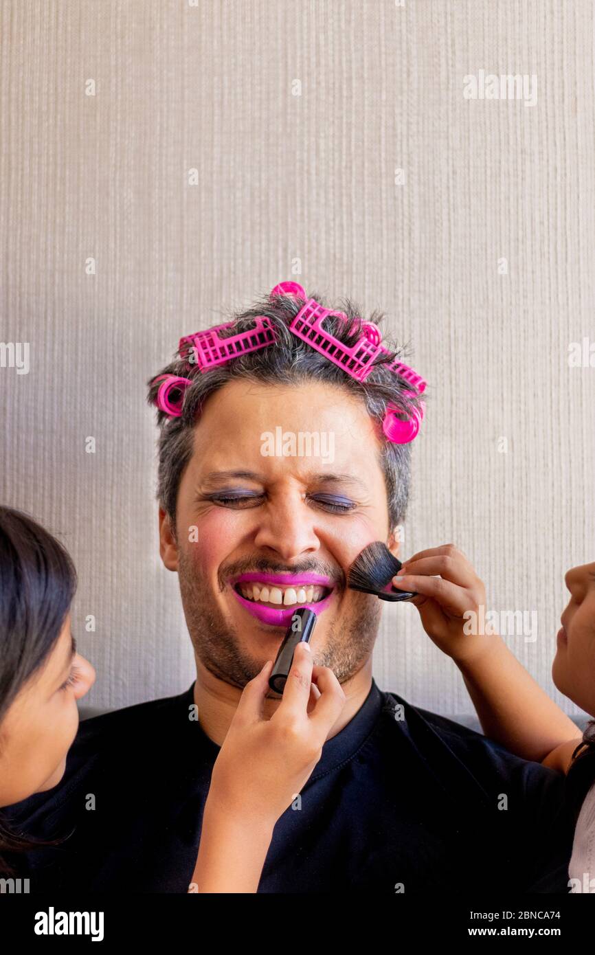 Handsome father is being makeup by the hands of his daughters Stock ...