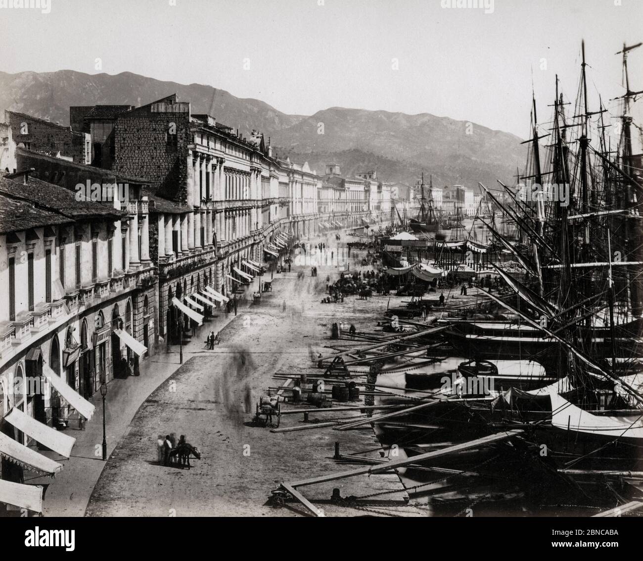View along the waterfront with ship tied up in the harbour, Messina ...