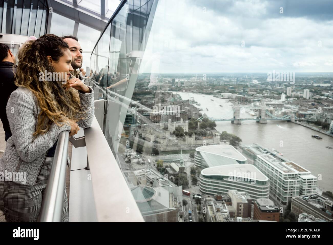 A young couple of tourist enjoying skyline of London from very high ...
