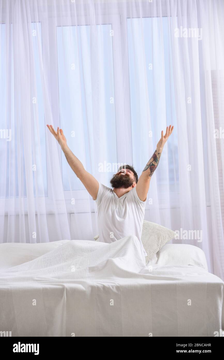 Guy on smiling face stretching arms upwards. Refreshment rest concept ...