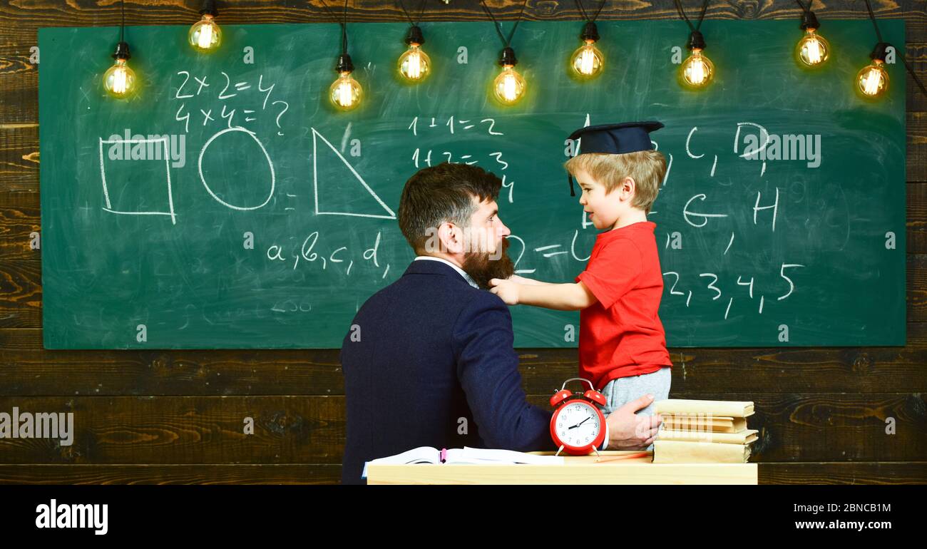 Young male teacher guides his child student to learning while speaking ...