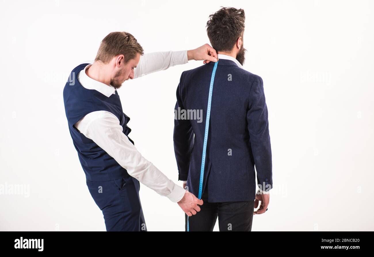 Businessman, client, customer visit tailor salon. Tailor measures back ...
