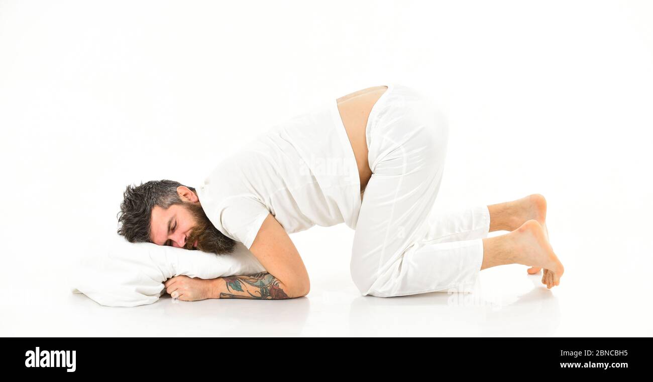 Hipster with sleepy face lies on pillow, heavy sleeper. Heavy sleeper ...