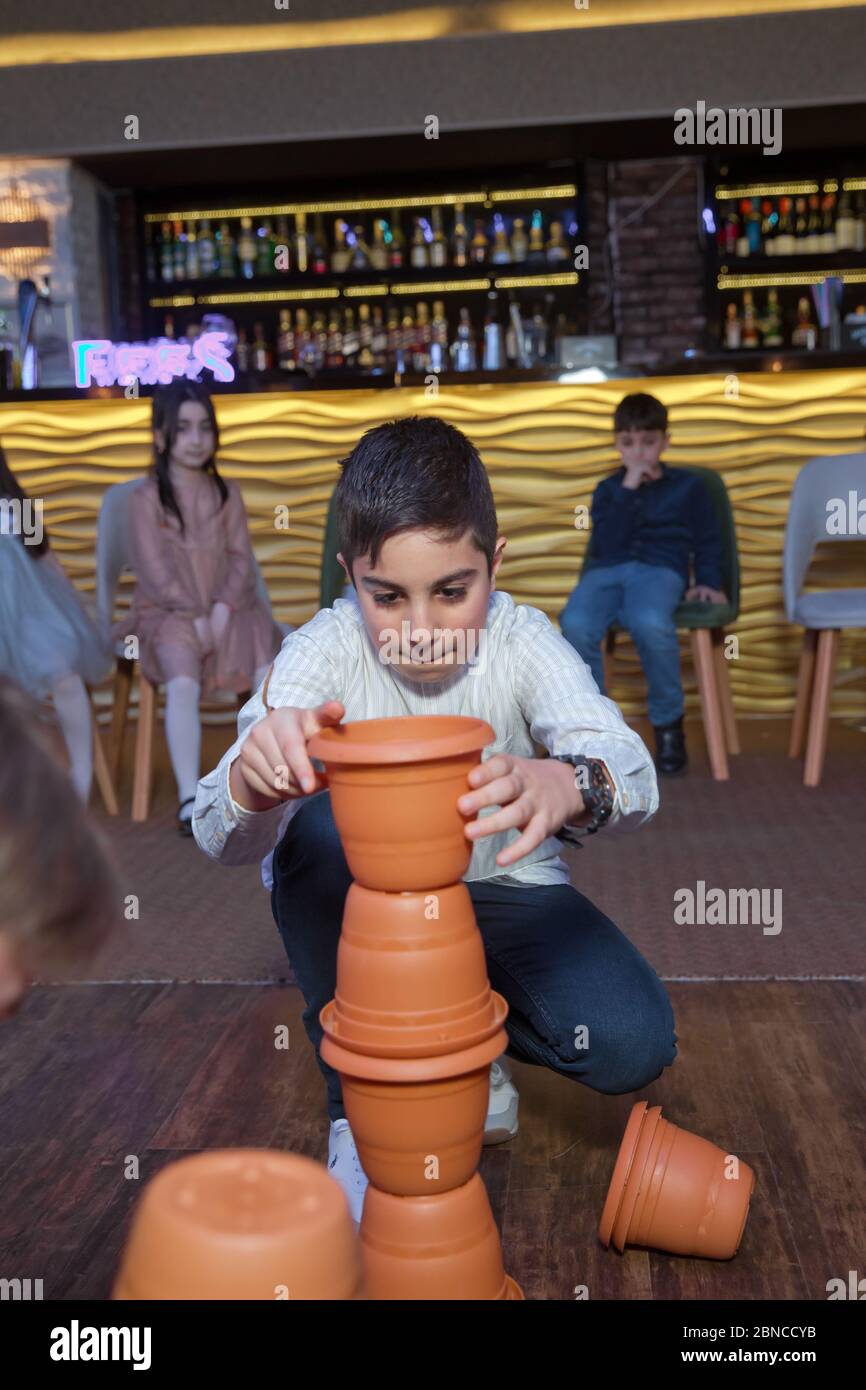 Cups to build a tower as toy for children on white Stock Photo - Alamy