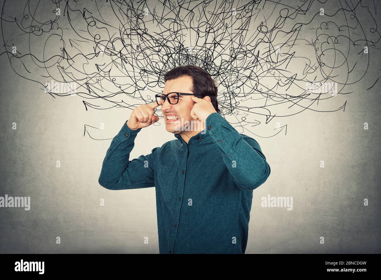 Annoyed irritated businessman, frowning and screaming due noise in head ...