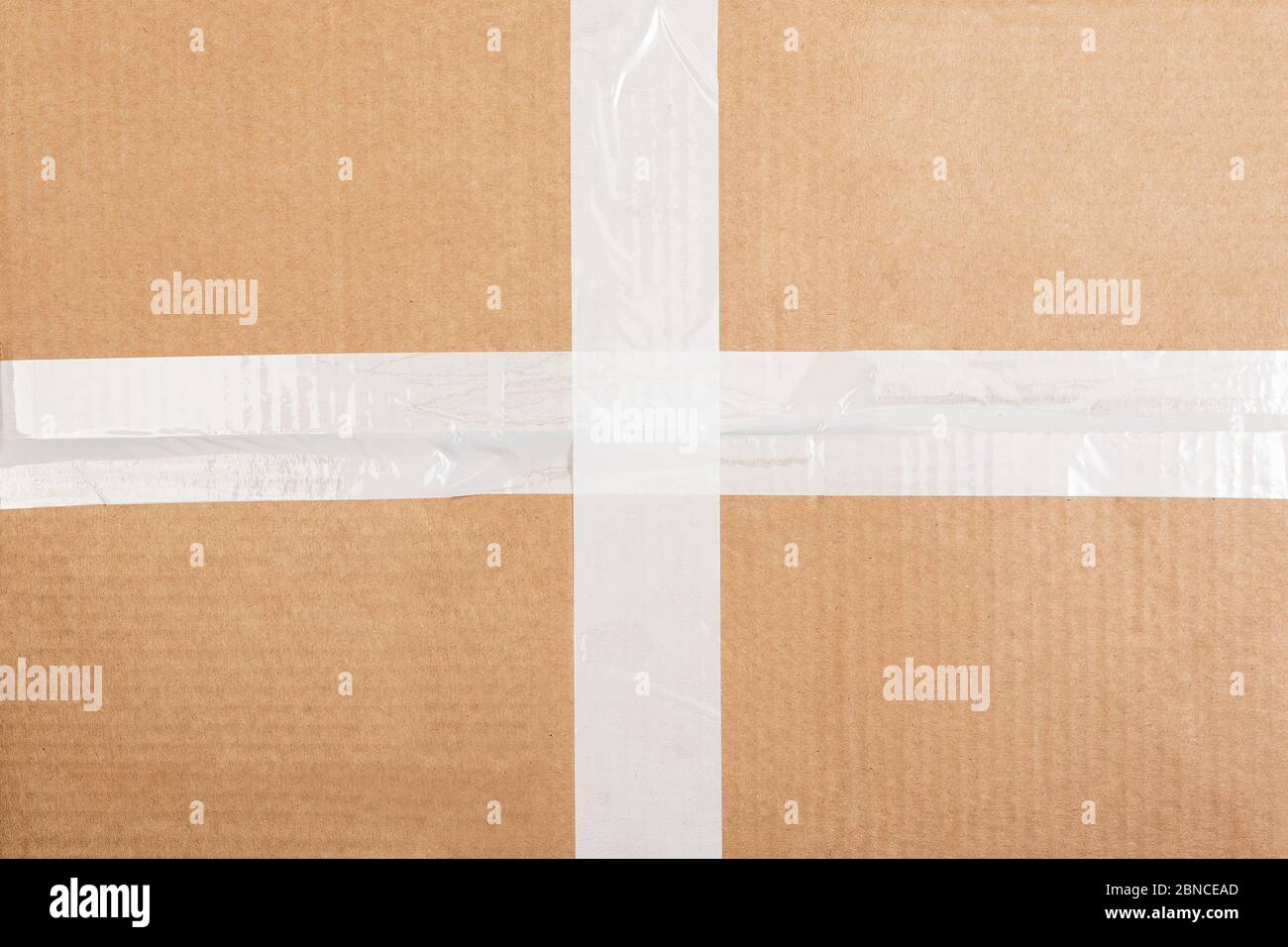 Cardboard box background with white sticky tape. Box packaging ...