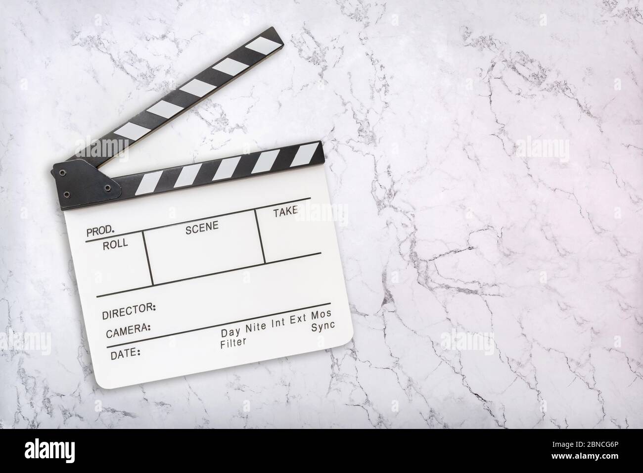 Clapboard on white marble background. White clapper board with space ...