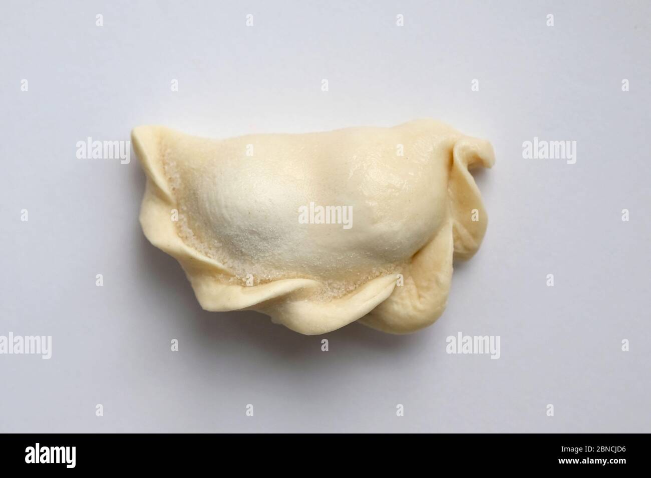 Raw dumpling with cherry top view. Dumplings with cherries on a white ...