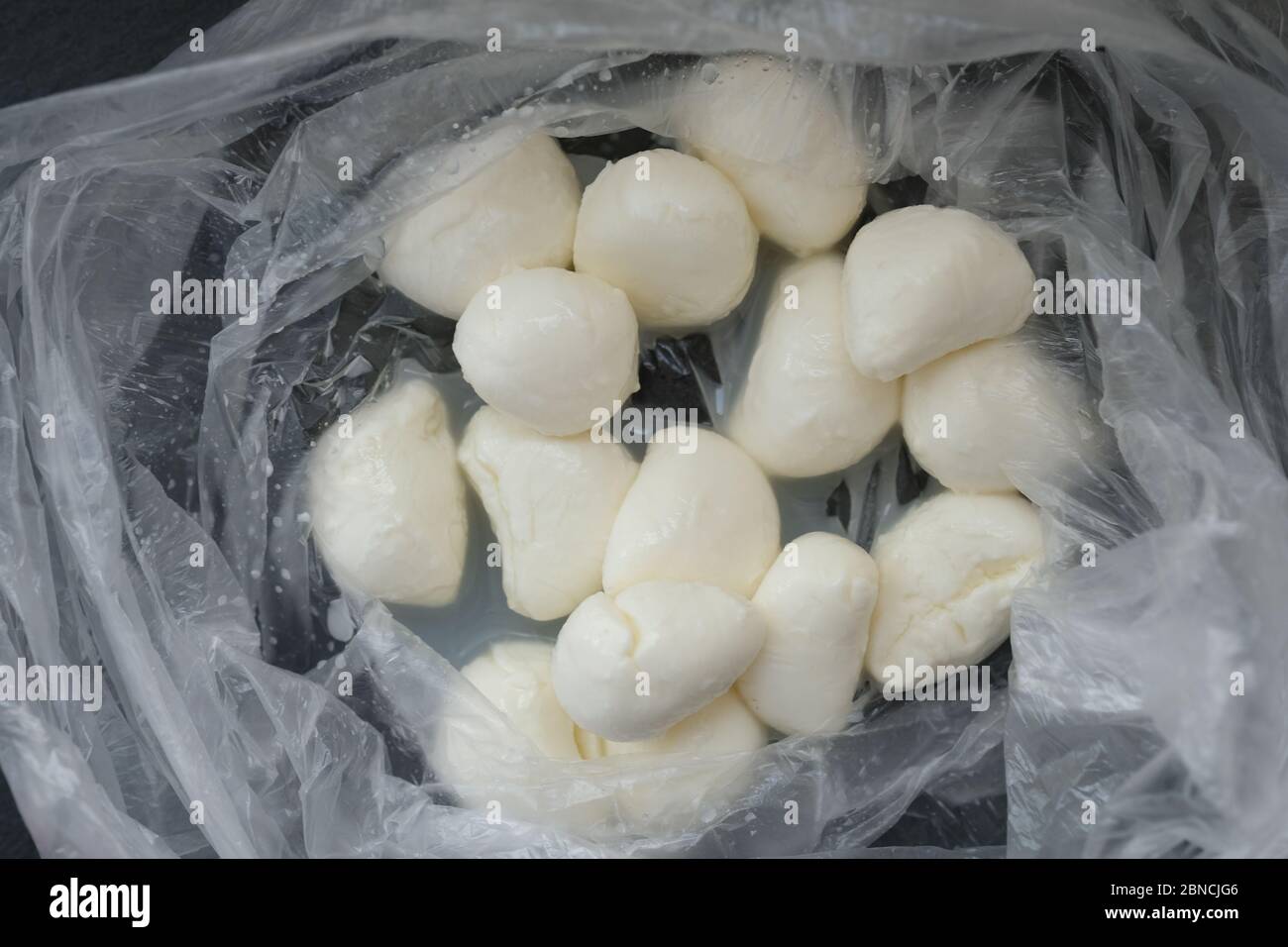 Mozzarella balls in a transparent plastic bag. Mozzarella cheese fresh ...