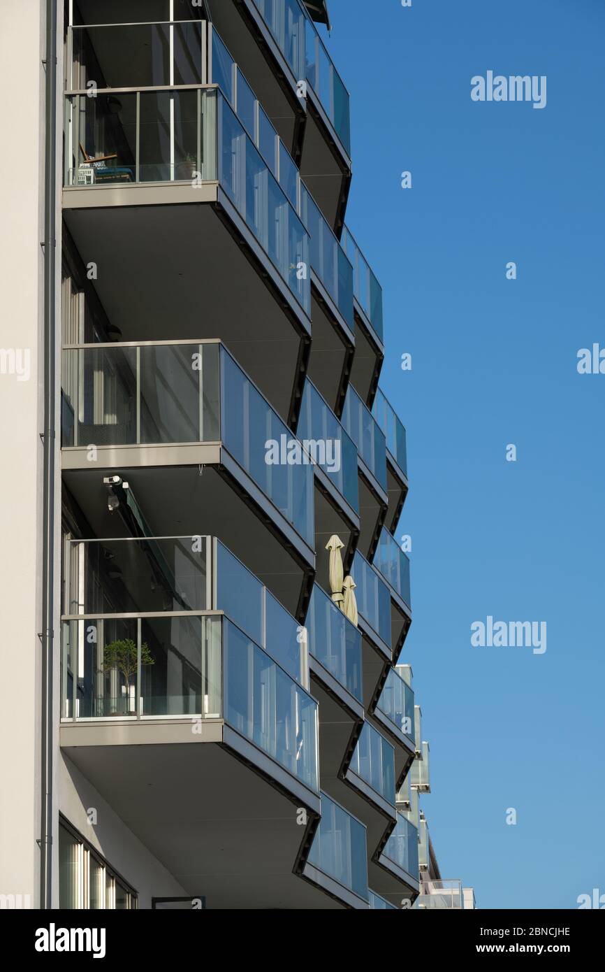 Mesmerizing view of a skyscraper with balconies against the blue sky ...