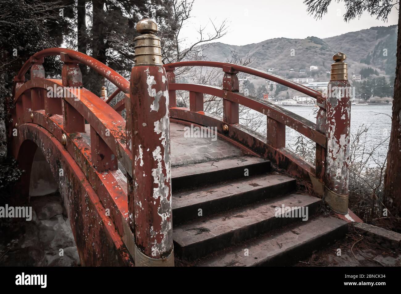 The red old traditional bridge in the pilgrimage route of Hakone Shrine ...