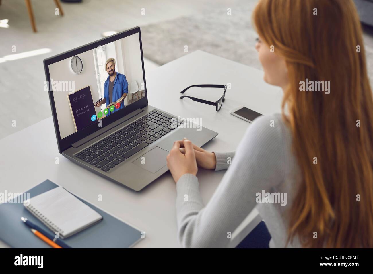 Online home lecture training. Student girl listening to teacher video ...