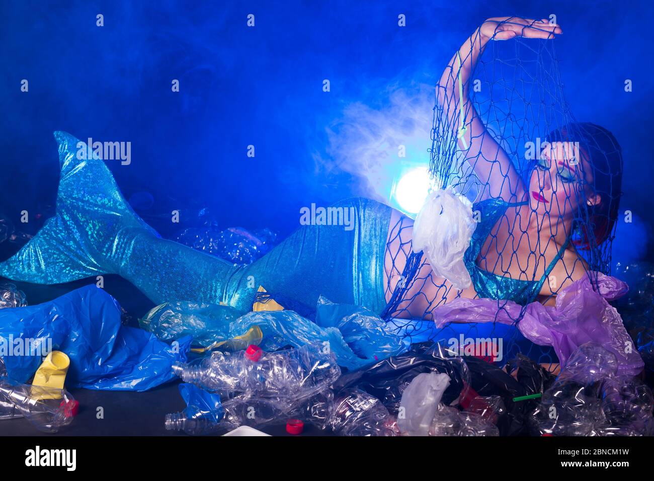 Sad fairytale mermaid in polluted ocean. Plastic trash and garbage in ...
