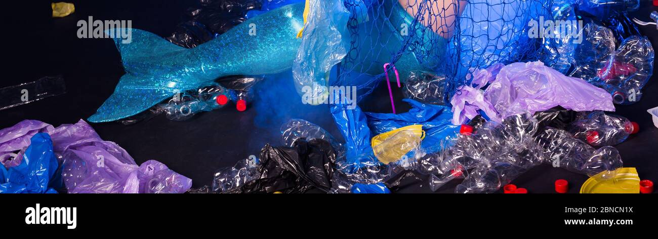 Ocean pollution, rubbish in the water. Close-up of fairytale mermaid in ...