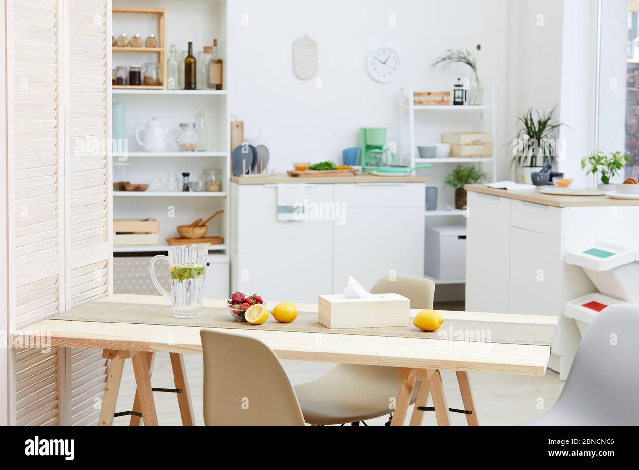 Image of wooden kitchen table with lemonade and fruits on it in ...