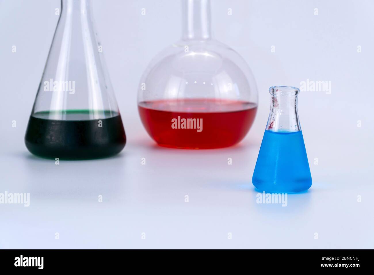 Laboratory glassware with liquid on white background. glass chemical ...