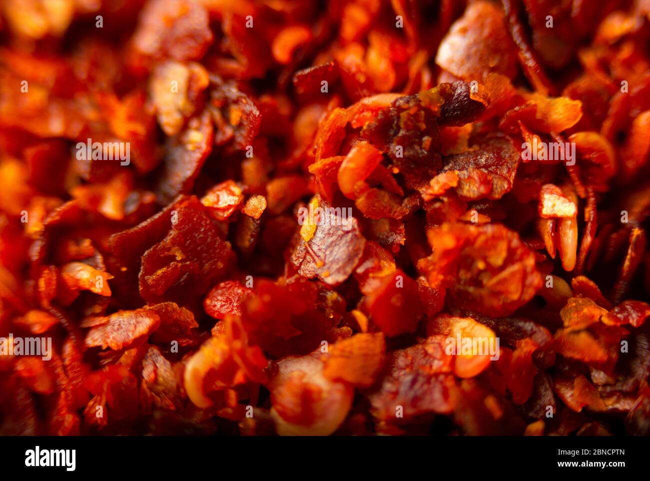 Red powdered pepper background texture close up Stock Photo - Alamy