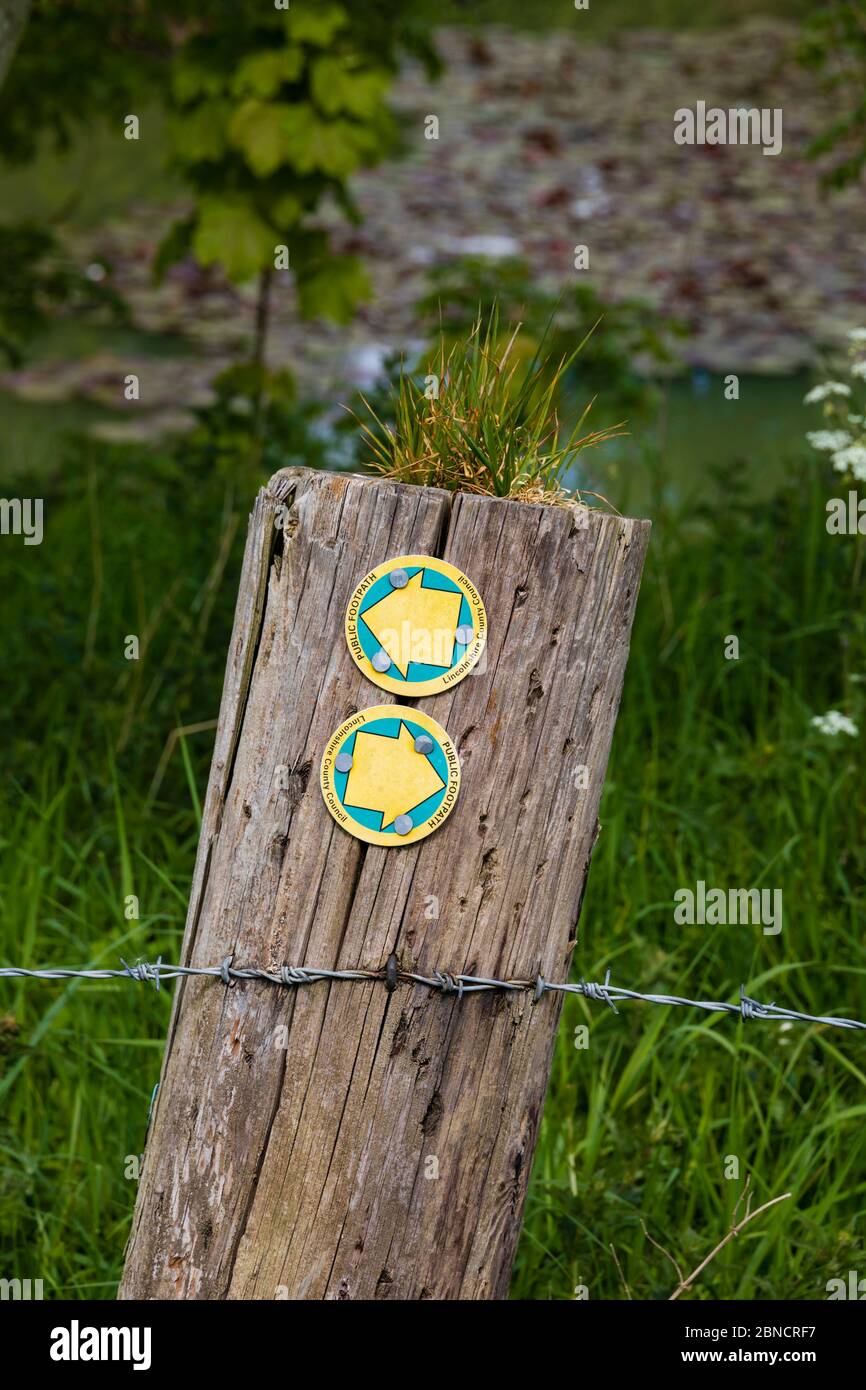 Post with sign denoting public footpath and directions, Lincolnshire ...